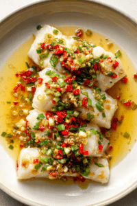 Chinese Steamed Cod Fish with Ginger Scallion Sauce - homeasyrecipes